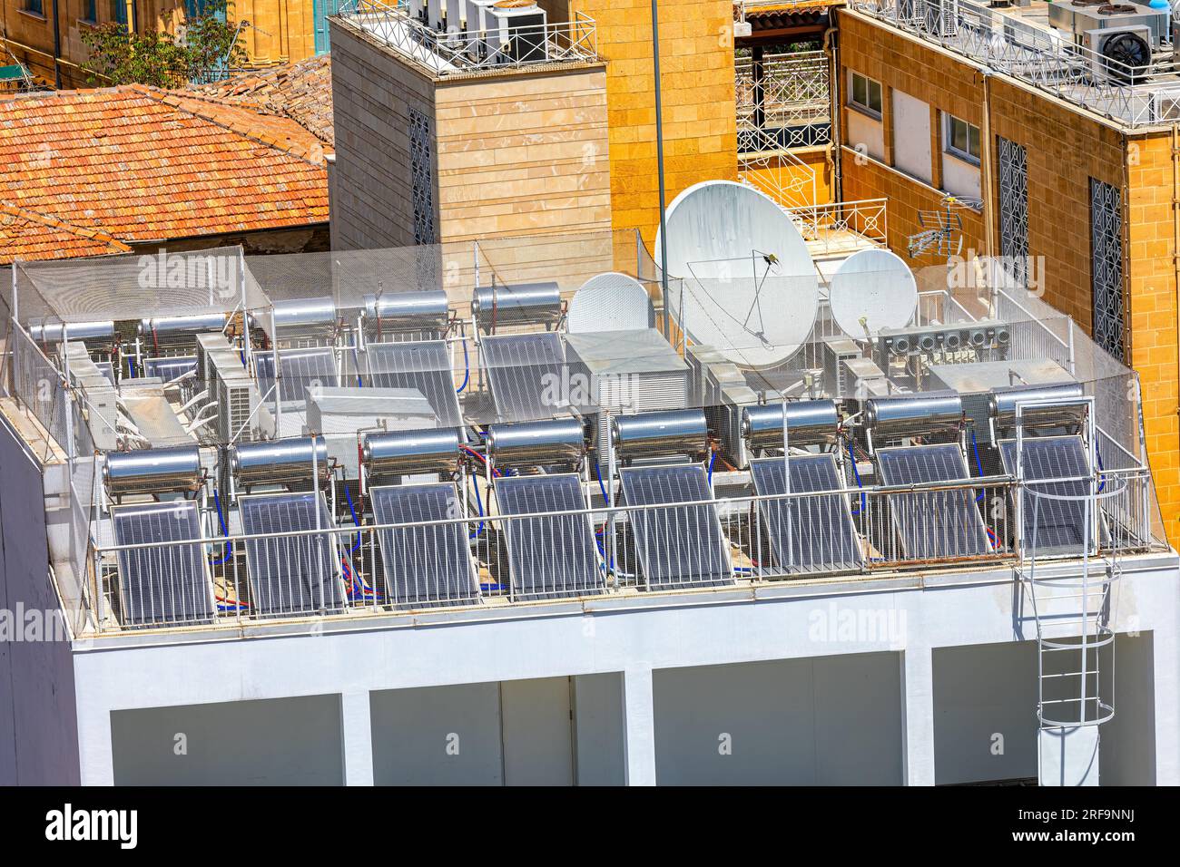 Solar panels on the roof of a building . Rooftop with antennas and ...