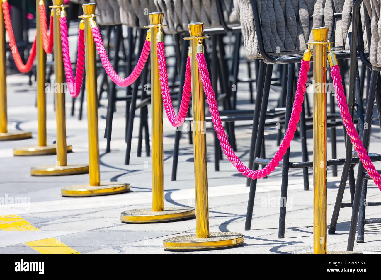 Red and yellow rope barrier in a restaurant . Street barrier of ...