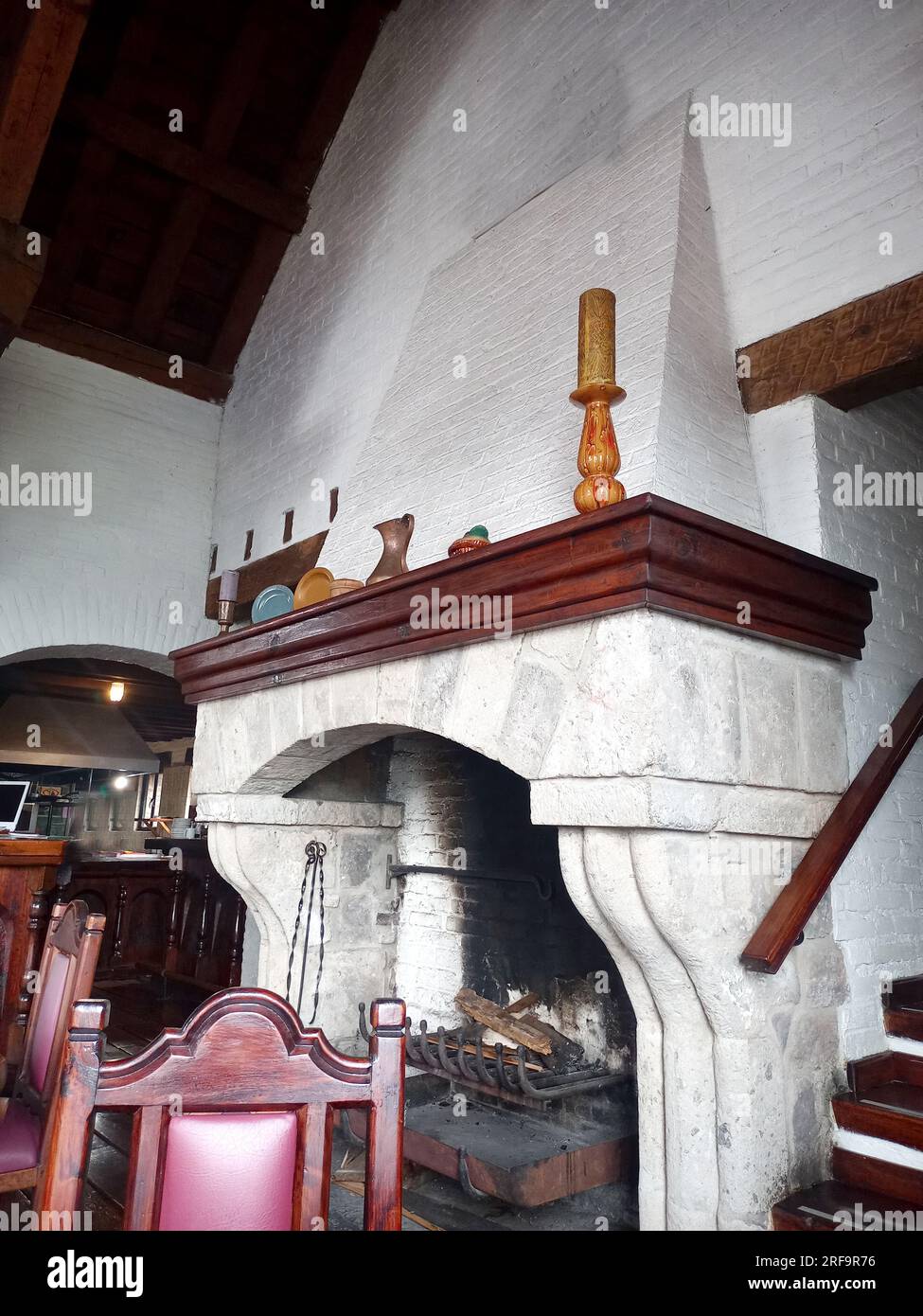 Empty restaurant with very elegant wooden tables, beamed ceiling, huge ...