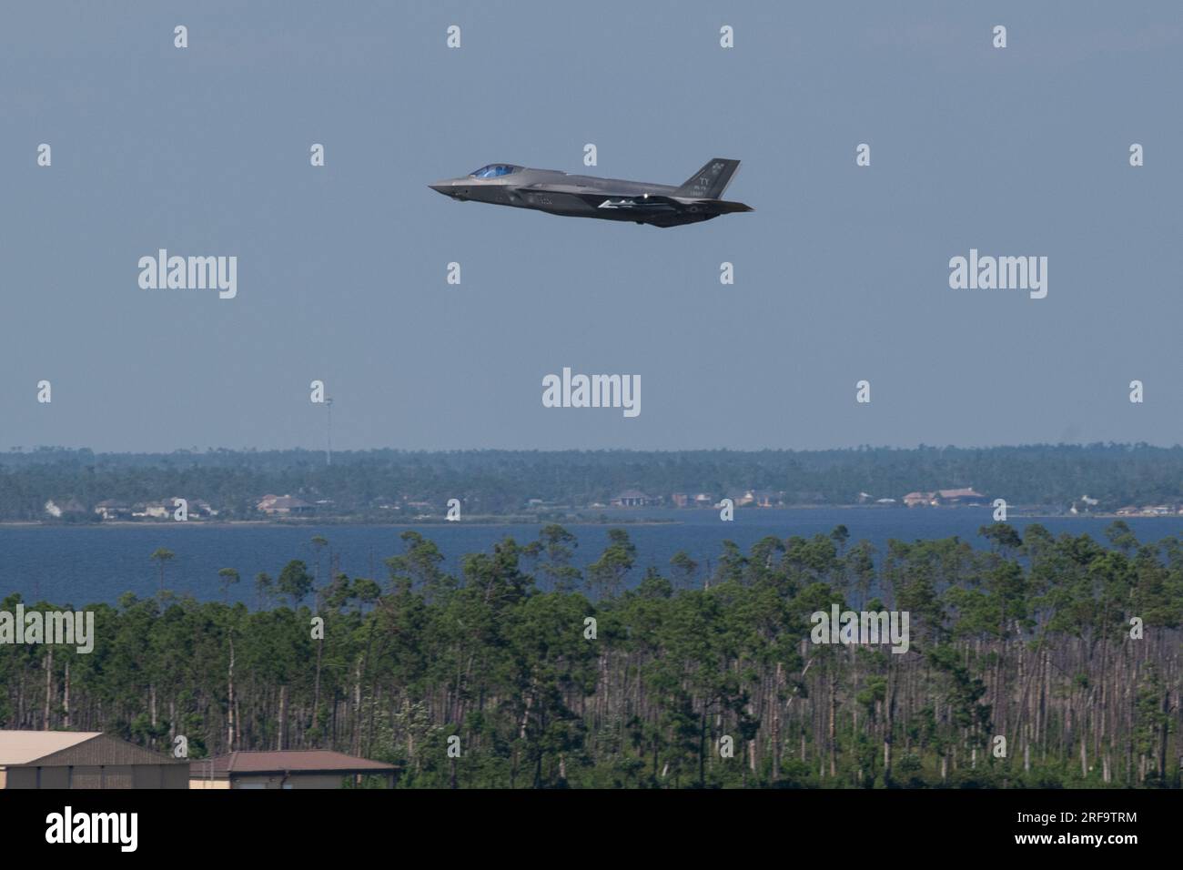A U.S. Air Force F-35A Lightning II flies over the airfield during an ...