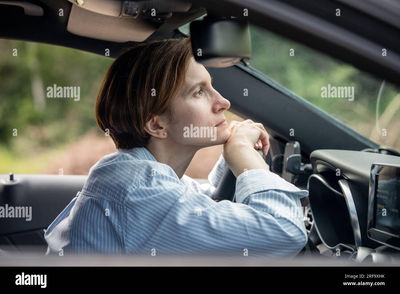 Middle aged frustrated woman driving car having problems on road waiting in traffic jam Stock ...