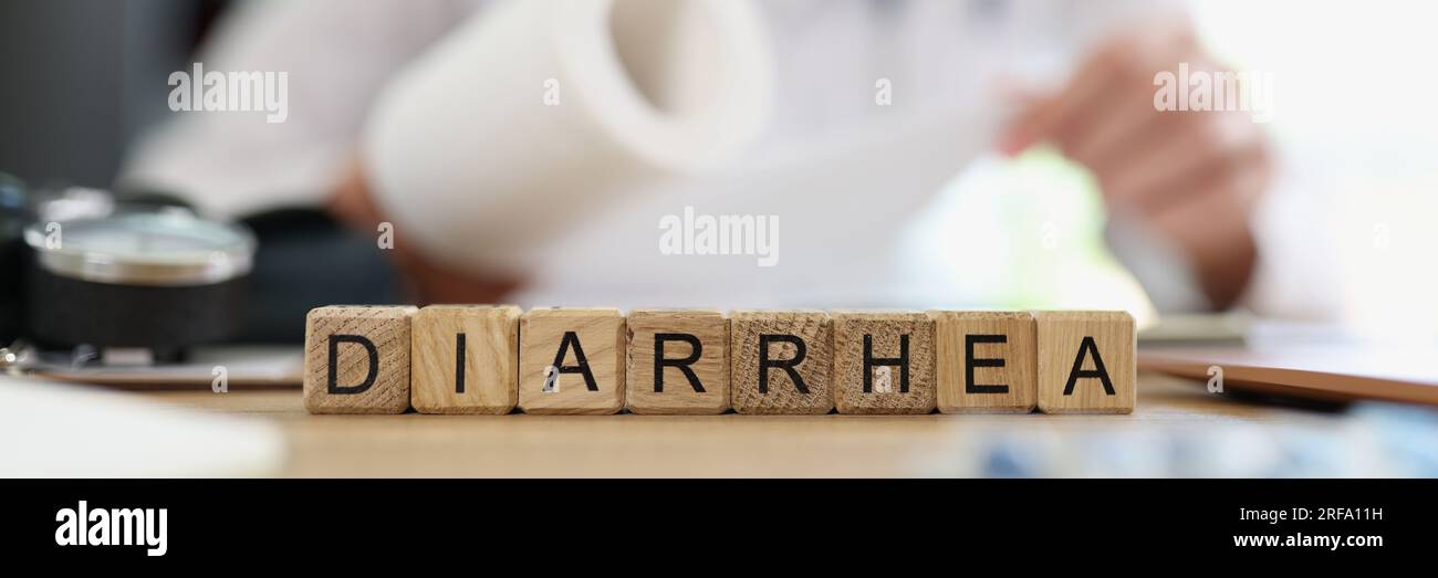 Blurred doctor with roll of toilet paper in hand and word diarrhea on ...