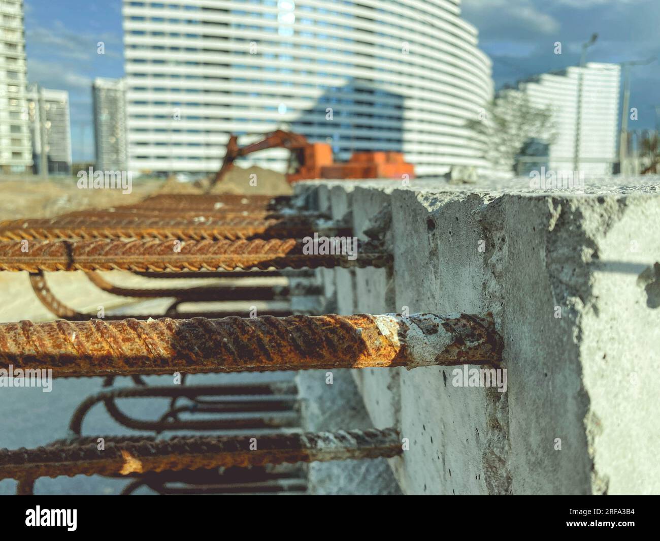 concrete block with rusty rebar sticking out inside. fasteners for the ...