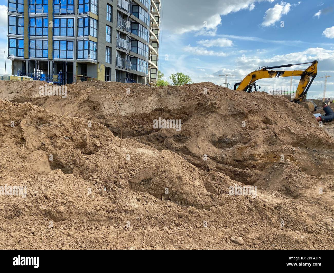 Excavator is digging a huge trench, ditch for drainage canal utility ...