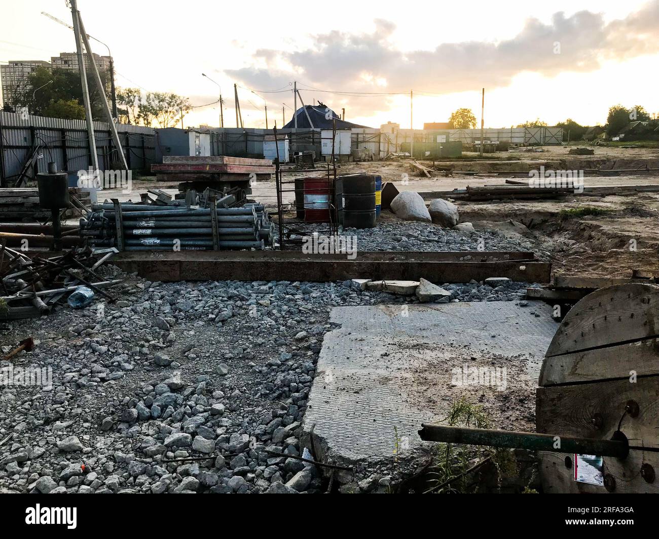 Inside view of a large industrial construction site behind a fence with ...