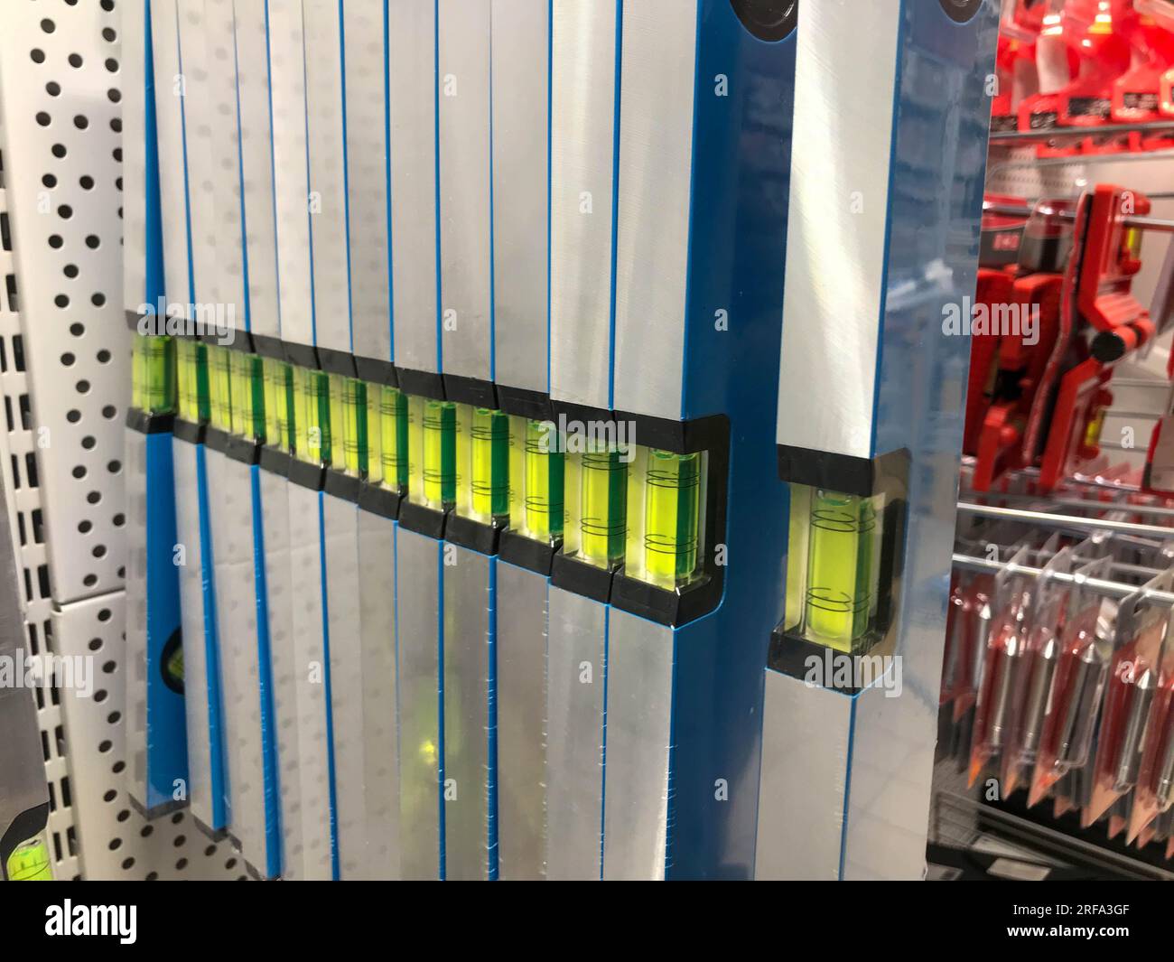 Tool level in men's hands and a flat horizontal surface of the ceiling ...