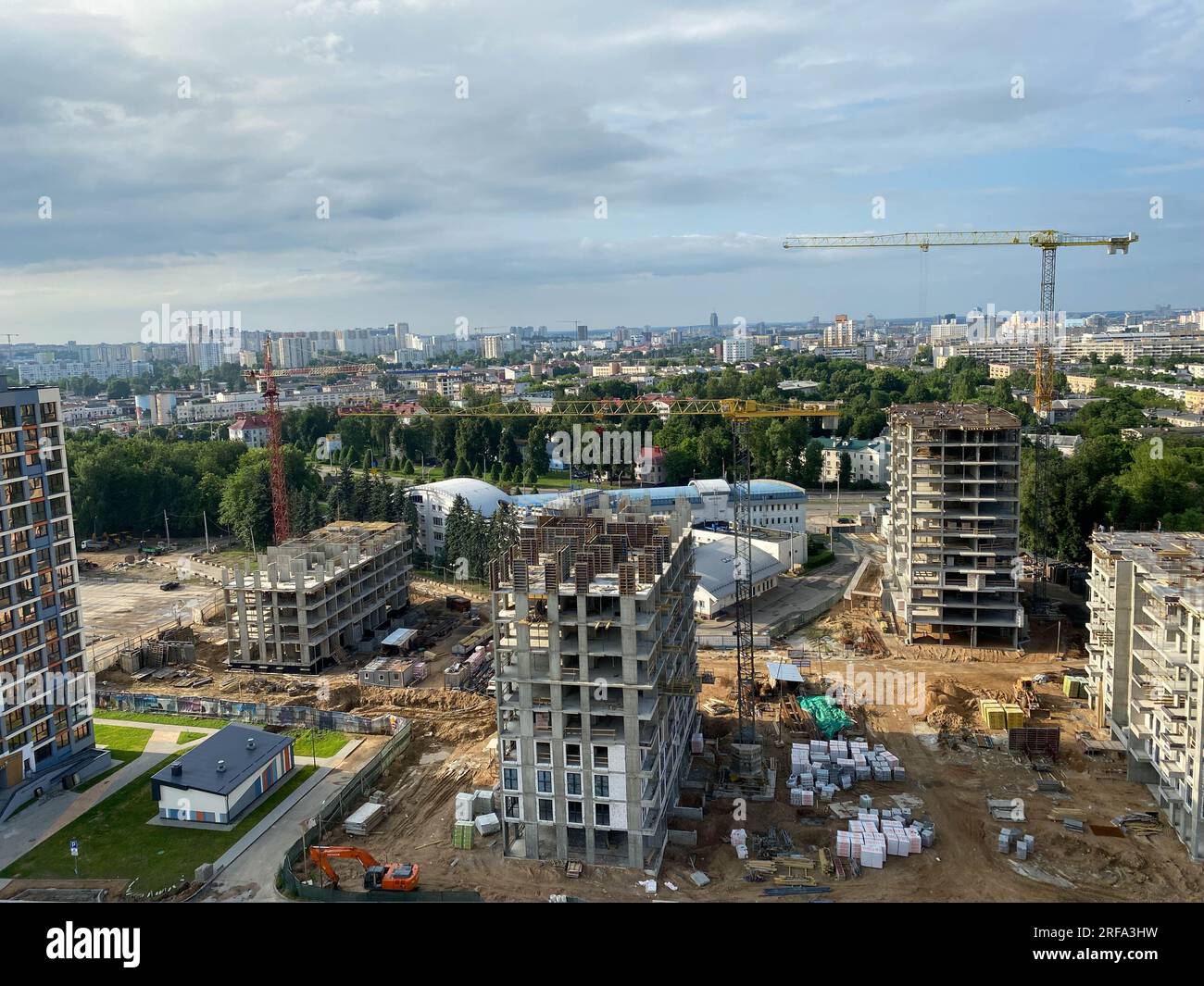 A view from a height of a large modern construction site of tall large ...