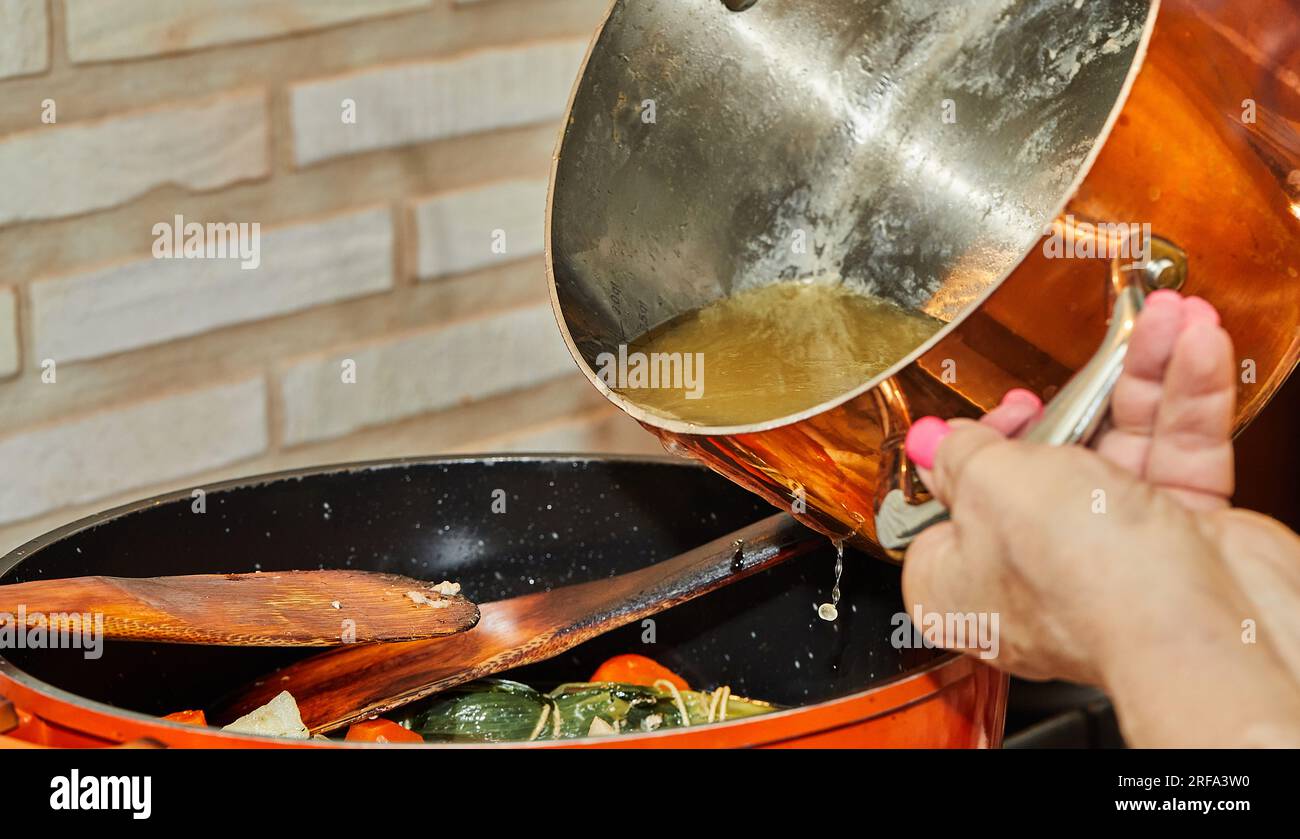 Pouring vegetable broth into soup hi-res stock photography and images ...