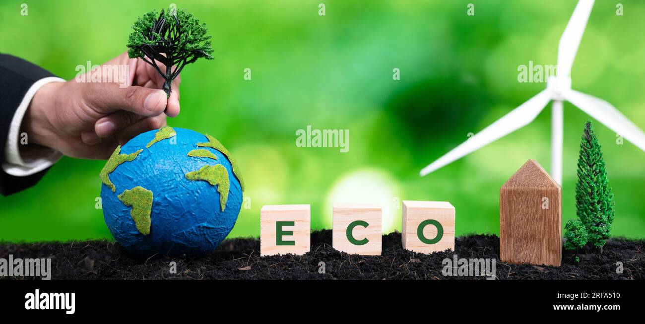 Businessman grow tree on paper globe with ECO cube symbol on fertile ...