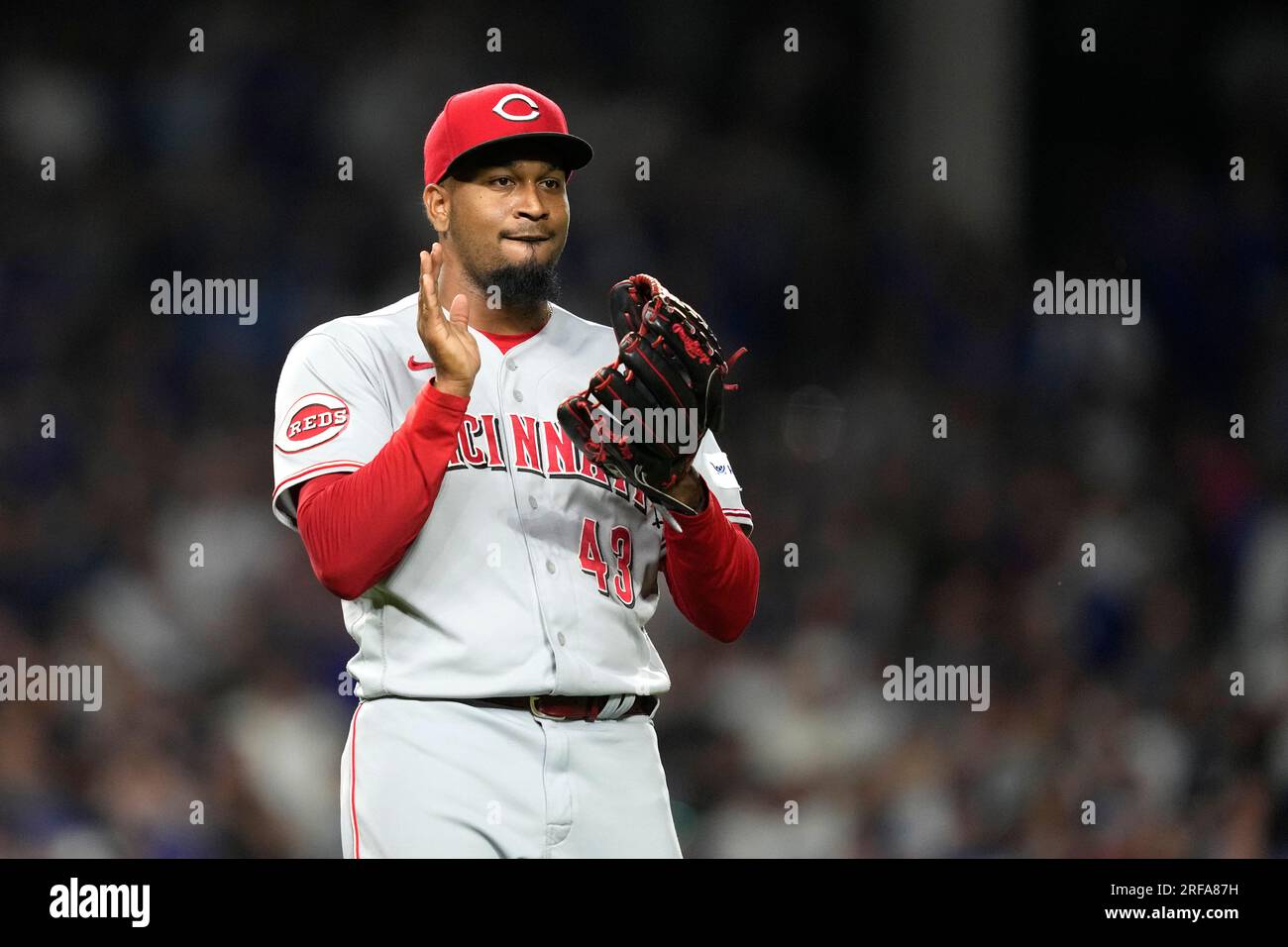 Cincinnati Reds relief pitcher Alexis Diaz applauds his teammates after ...