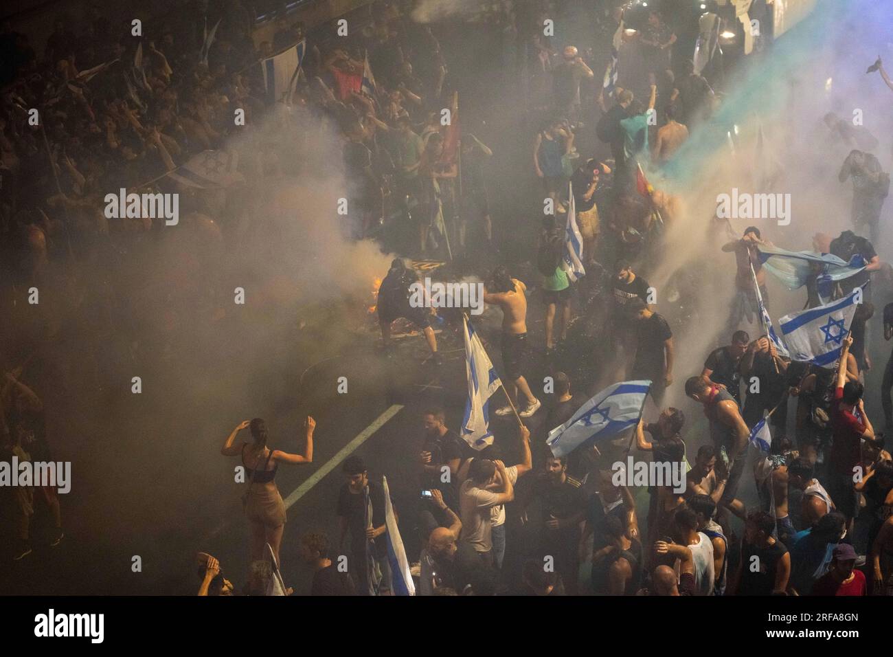 Riot police try to clear demonstrators with a water canon during a ...