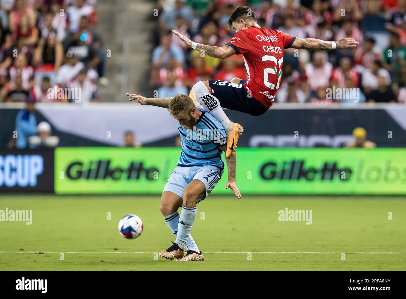 KANSAS CITY, KS - JULY 31: Chivas defender Cristian Calderón (26) falls ...