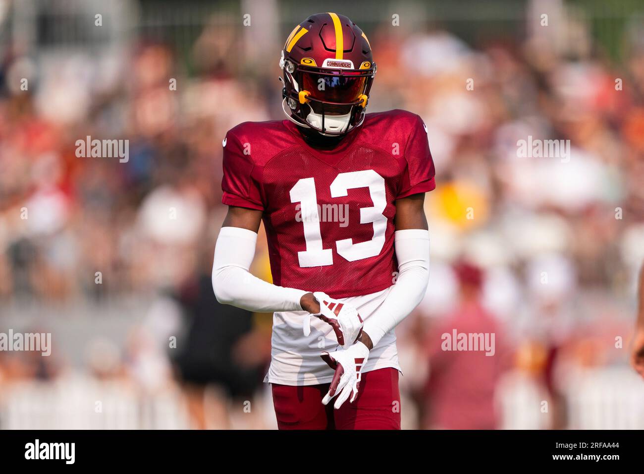 Washington Commanders cornerback Emmanuel Forbes pulls on his gloves ...