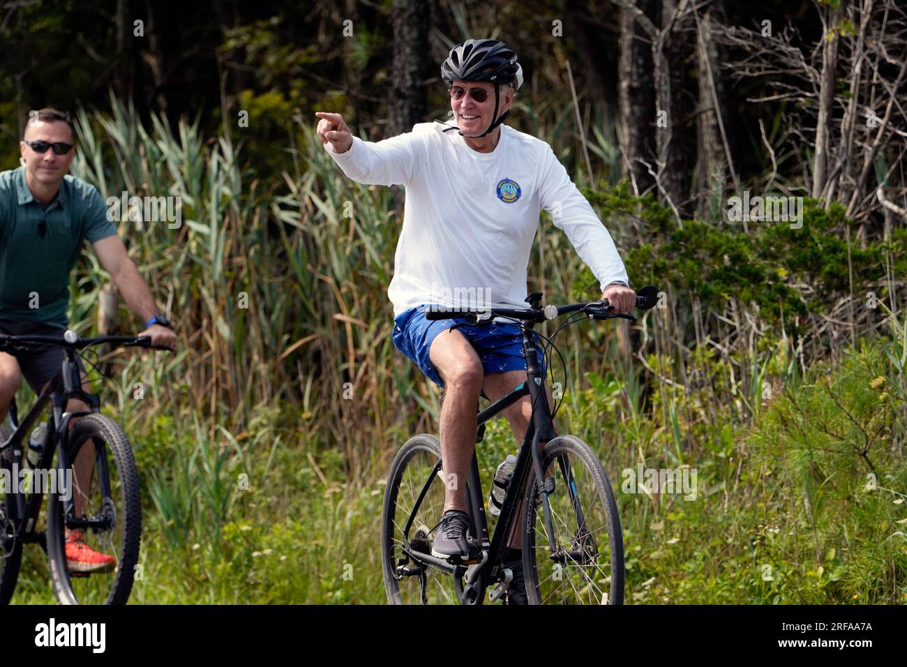 President Joe Biden rides his bike at Gordons Pond in Rehoboth Beach ...