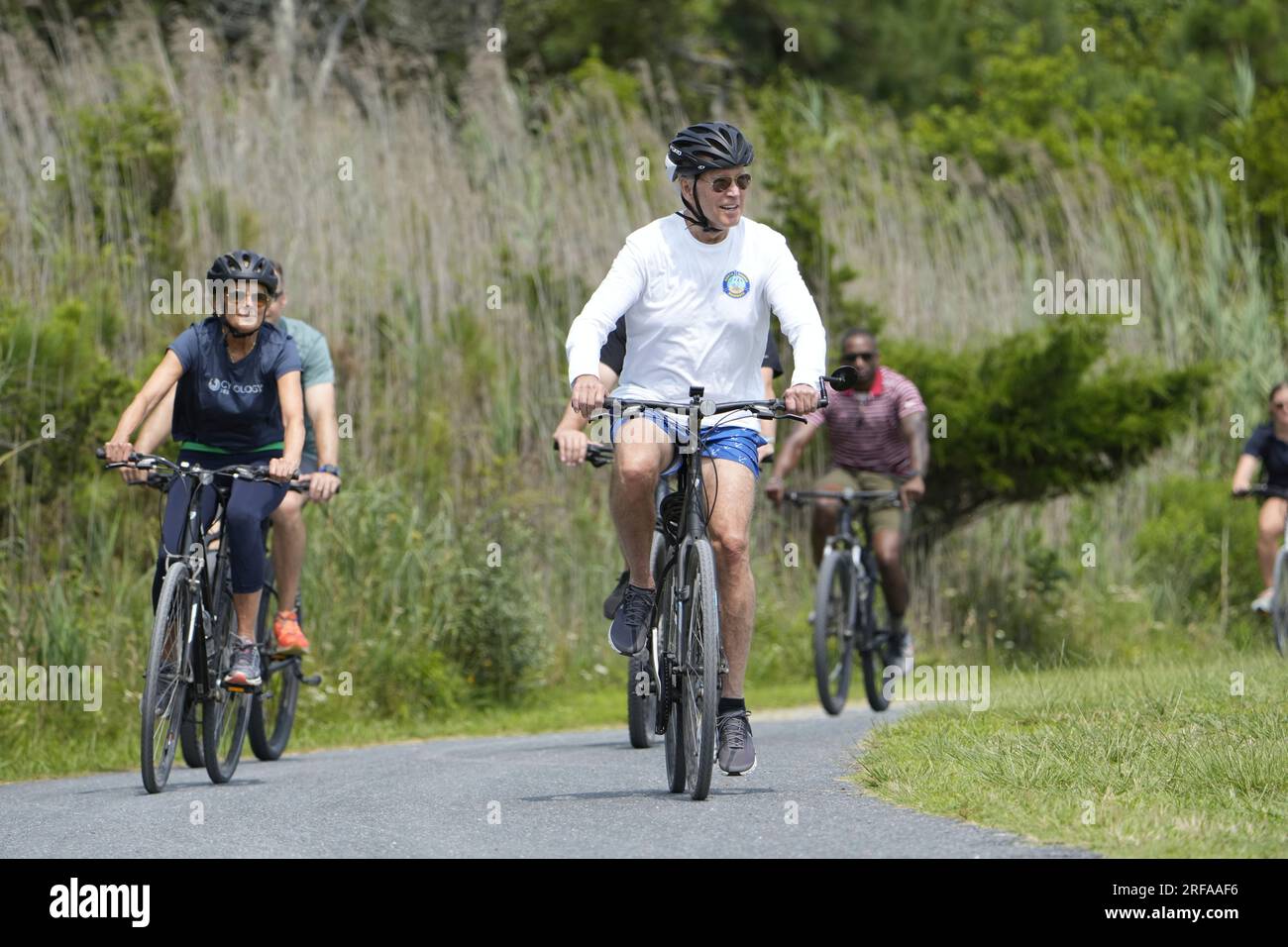 President Joe Biden and first lady Jill Biden ride their bikes on a ...