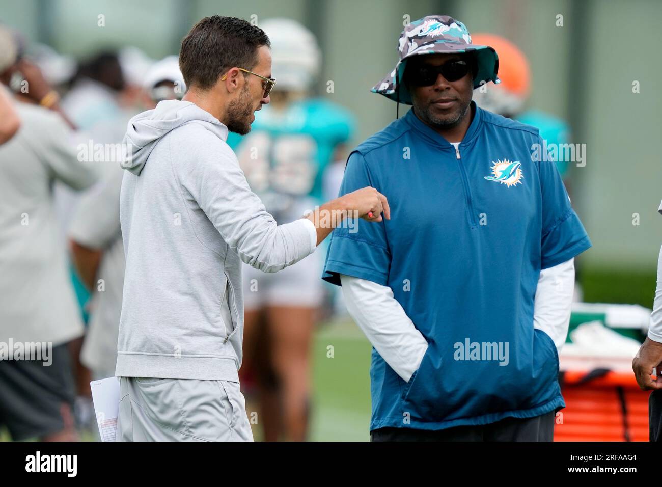 Miami Dolphins head coach Mike McDaniel, left, talks with general ...