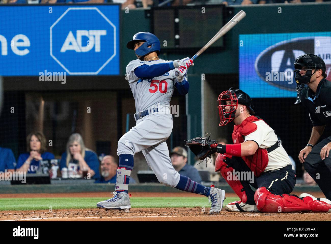 Los Angeles Dodgers' Mookie Betts follows through on a swing as Texas ...