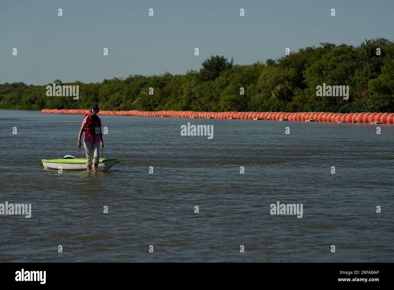 Texas state Rep. Vikki Goodwin pulls her kayak during a trip to view large buoys being used as a ...