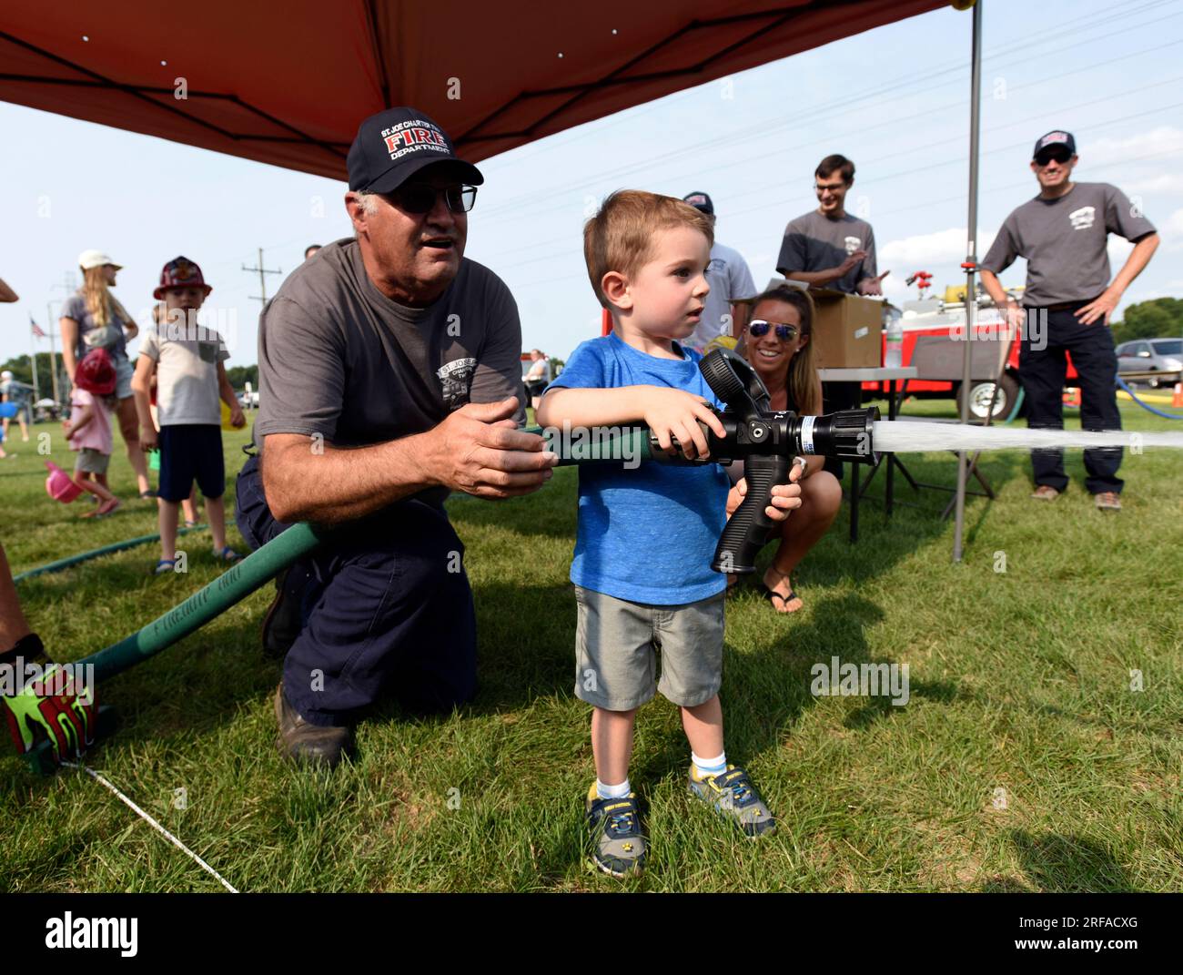 St. Joseph Township firefighter Lewis Elkins helps Jackson Visel, 3 ...