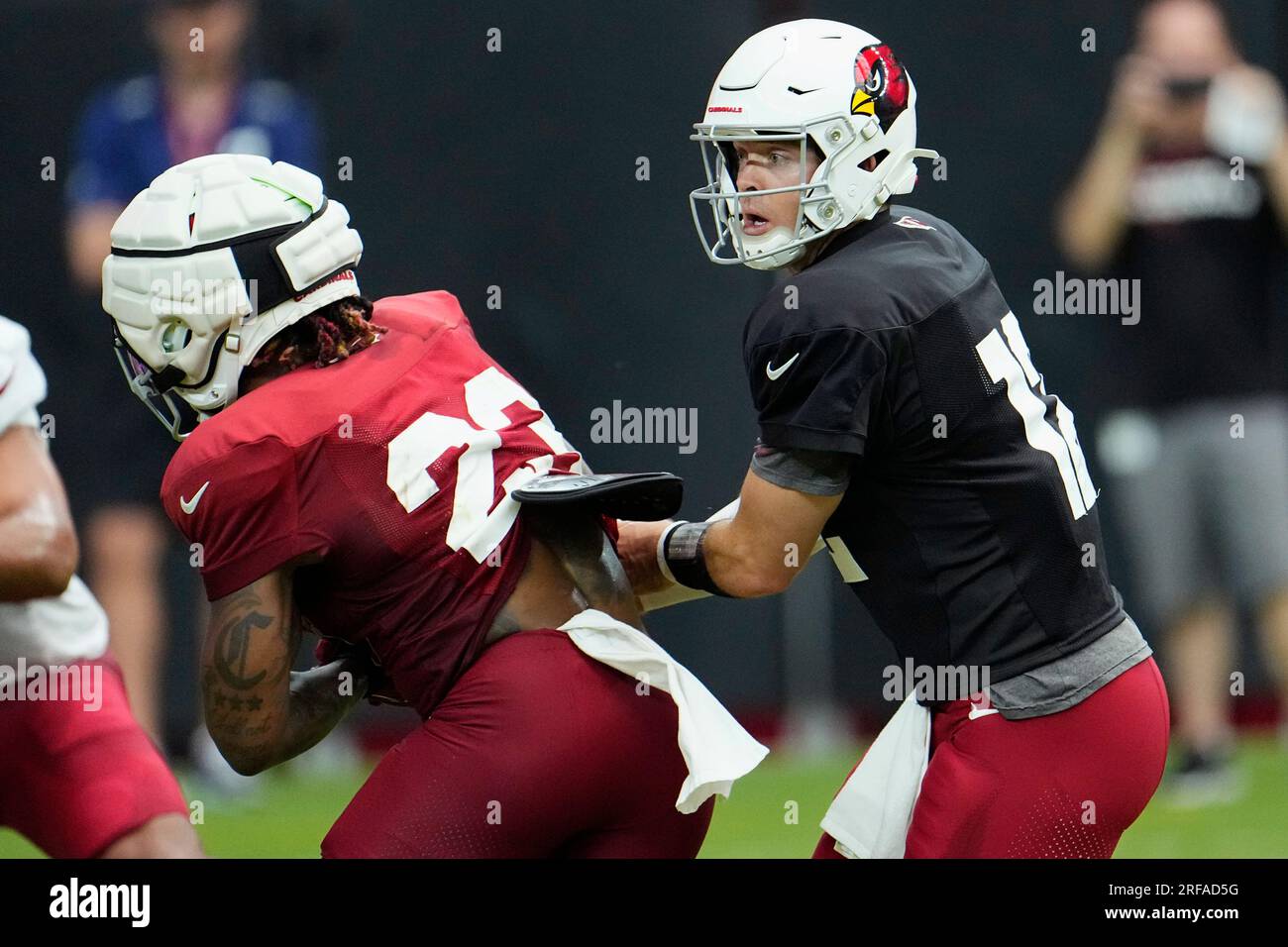 Arizona Cardinals quarterback Colt McCoy, right, fakes a handoff to ...