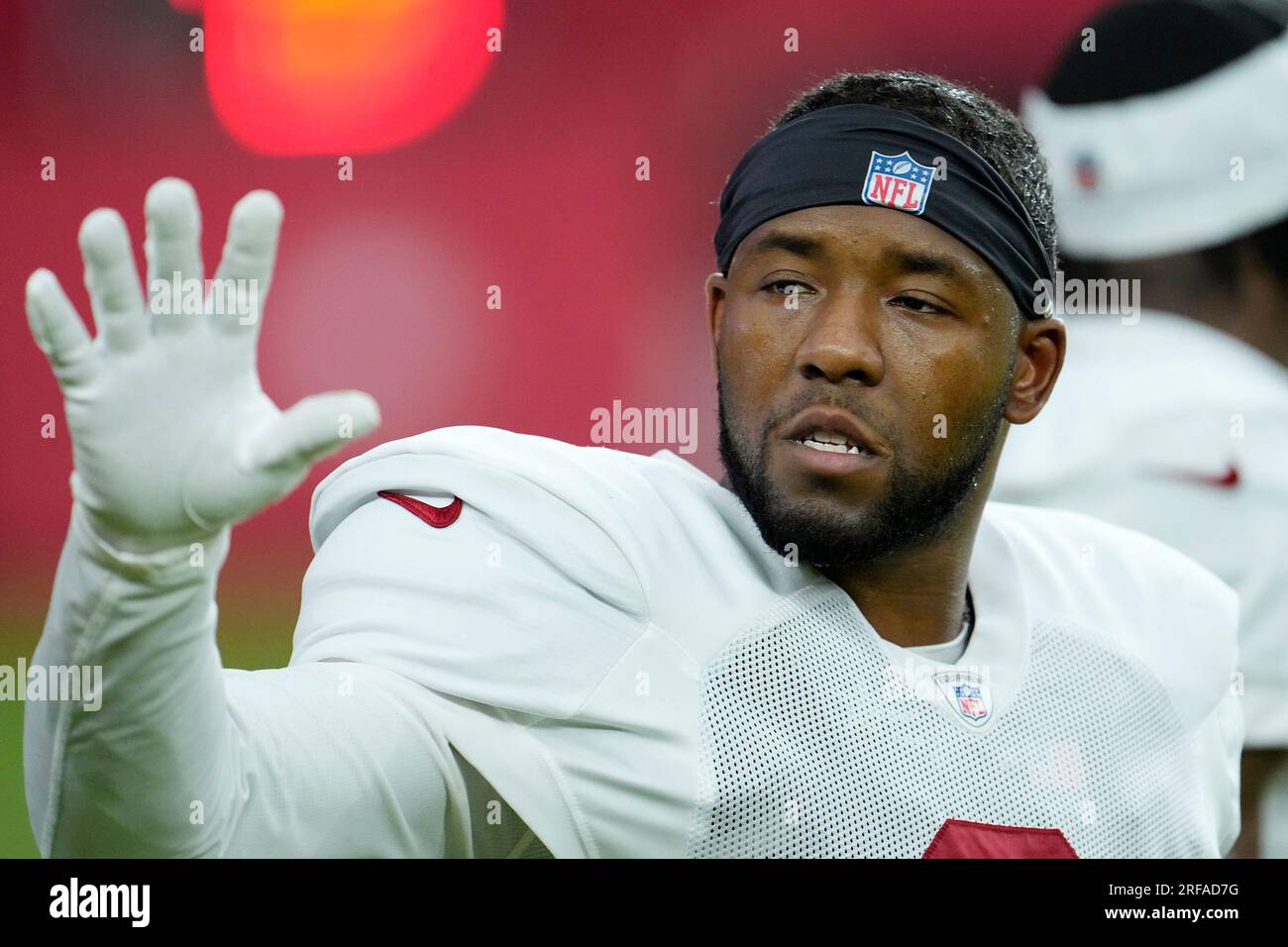 Arizona Cardinals safety Budda Baker waves to the crowd shouting his ...
