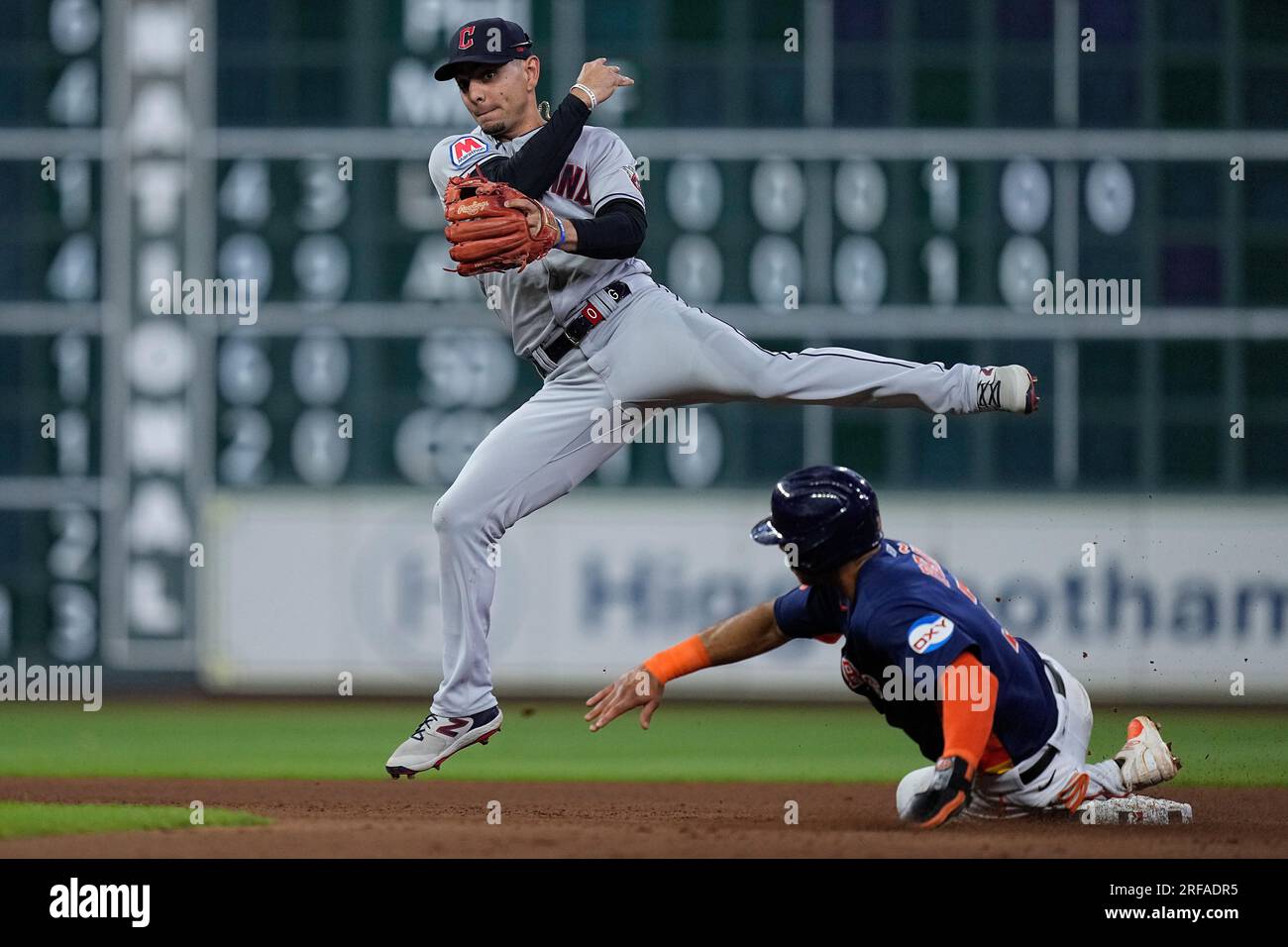 Cleveland Guardians second baseman Andres Gimenez leaps over Houston ...