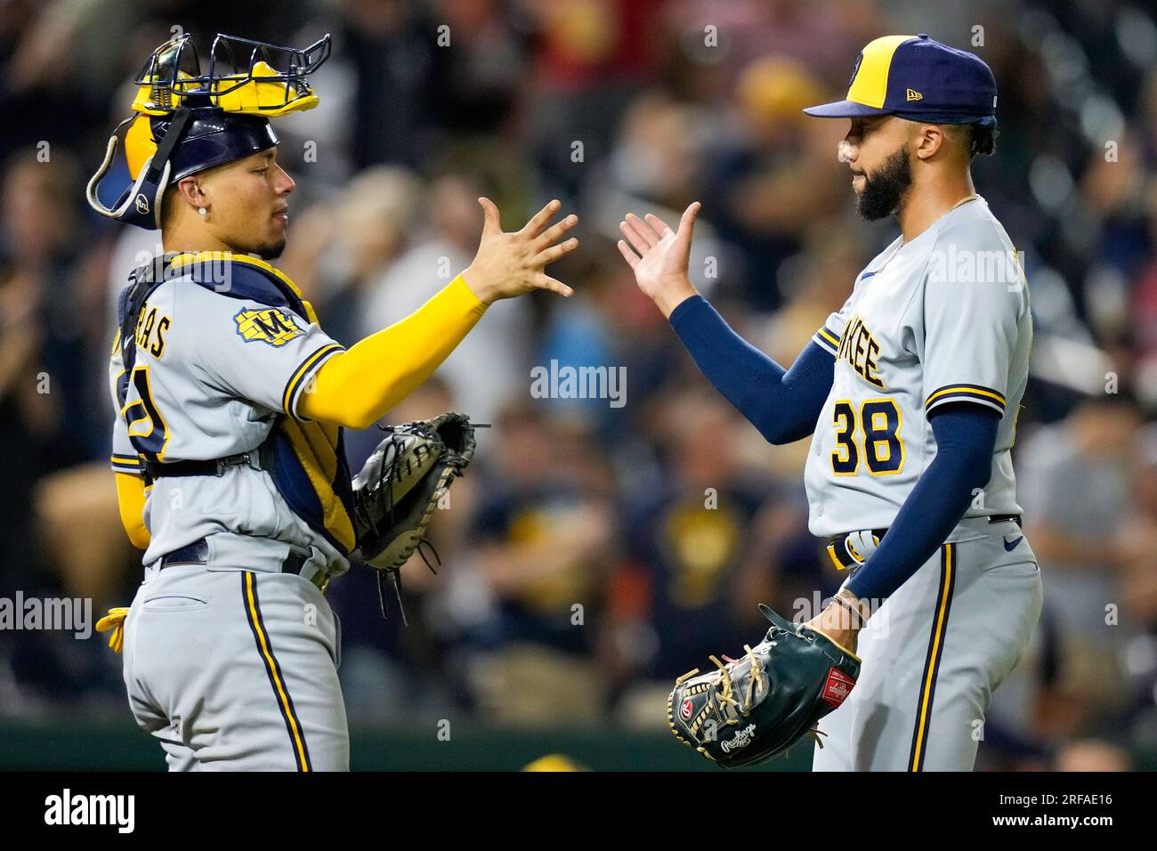 Milwaukee Brewers catcher William Contreras, left, and relief pitcher ...