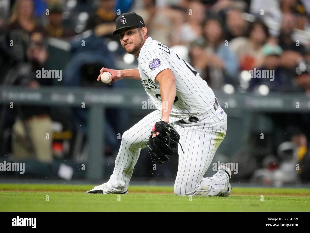 Colorado Rockies starting pitcher Peter Lambert fields infield single ...