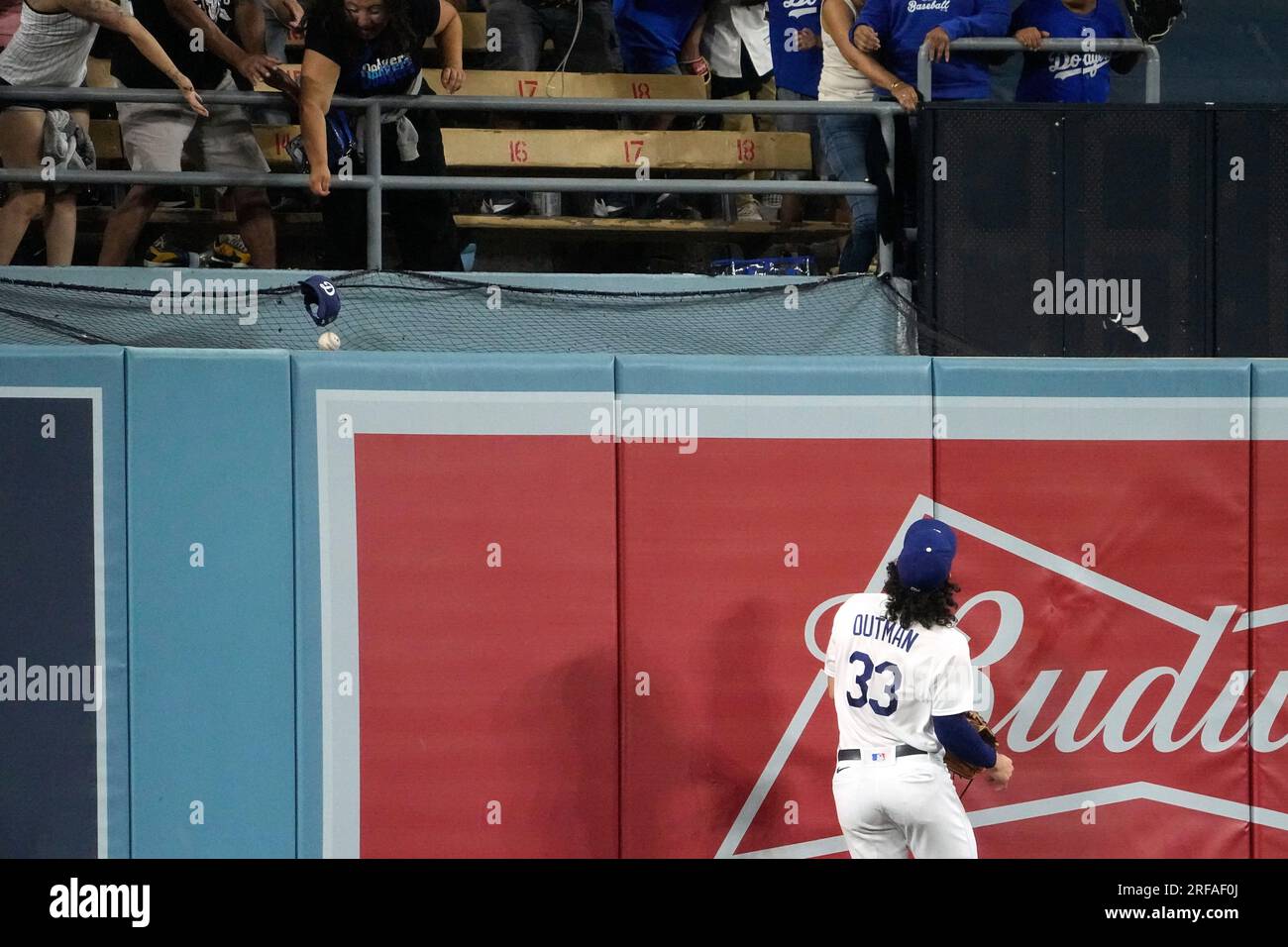 Los Angeles Dodgers center fielder James Outman can't get to a ball hit ...