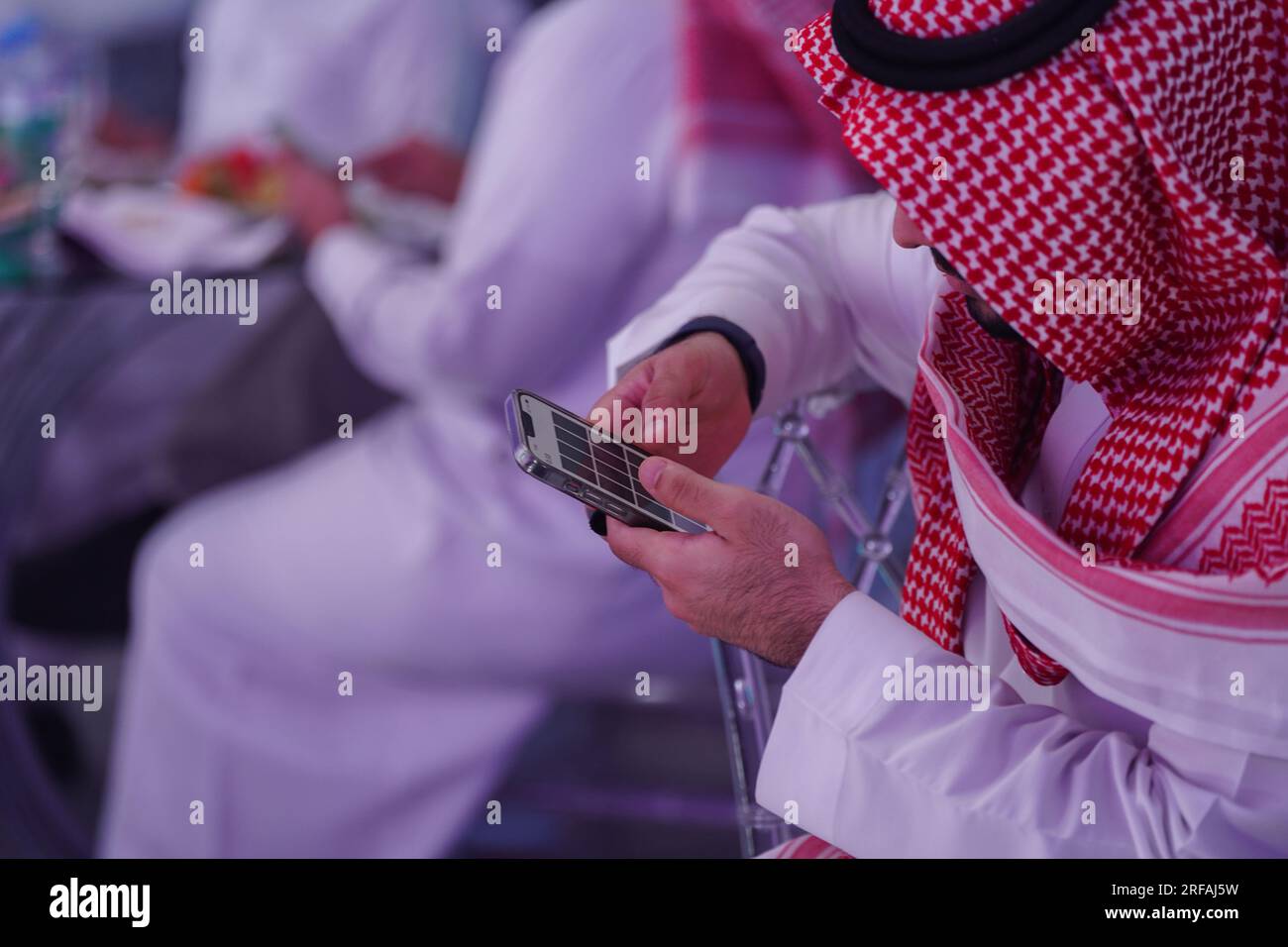 Saudi arab man Works on mobile phone reading or typing message Stock ...