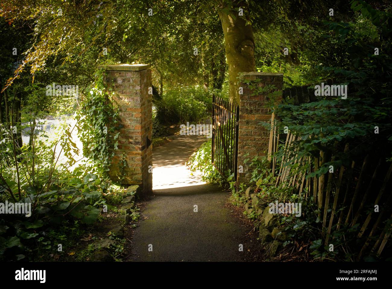 Open metal gate along a path in gardens Stock Photo - Alamy