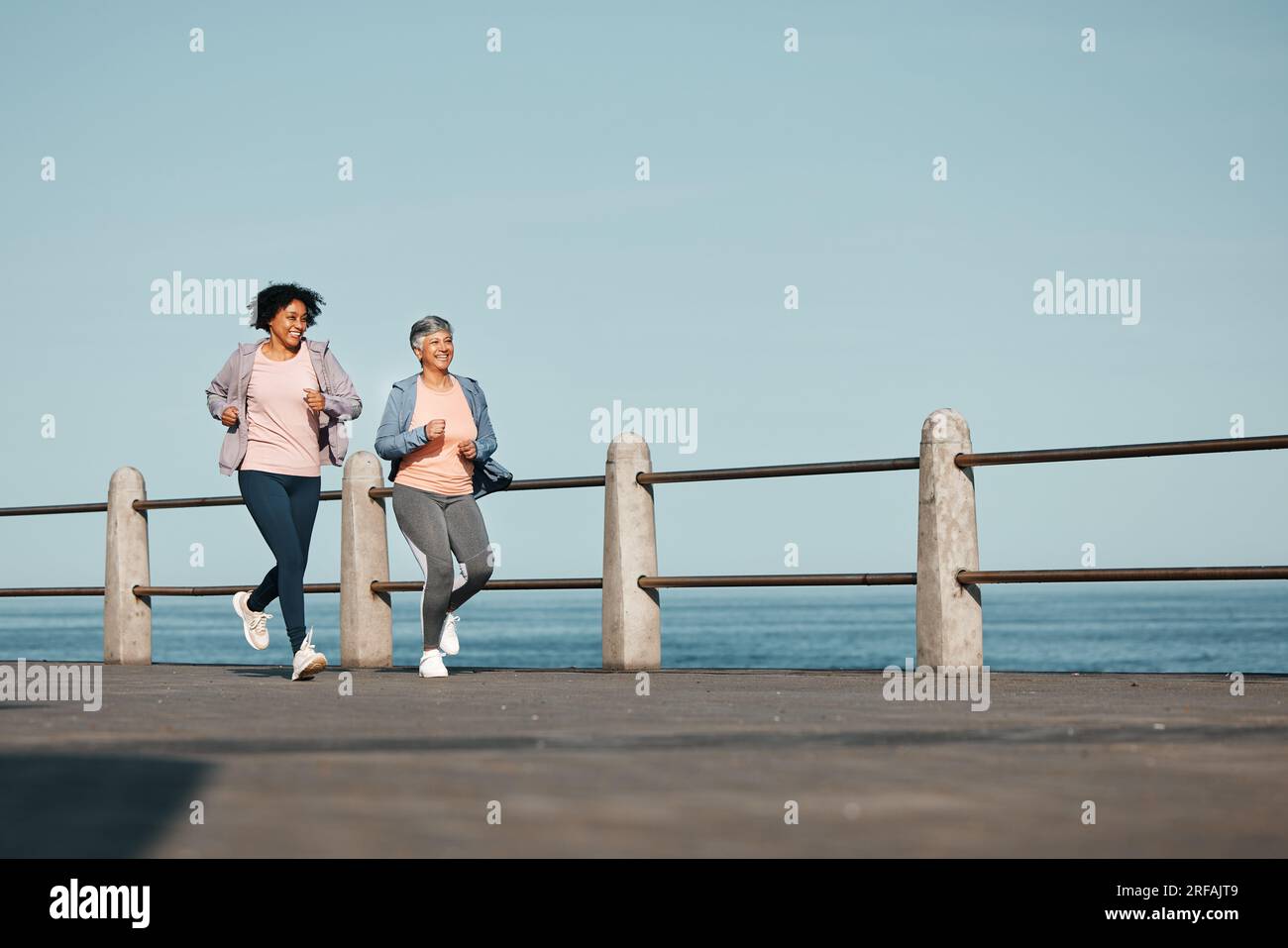 Senior, fitness and women friends at the beach for running, bond and ...