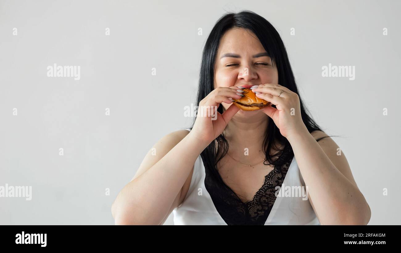Woman tries to choose between healthy and unhealthy diet Stock Photo ...