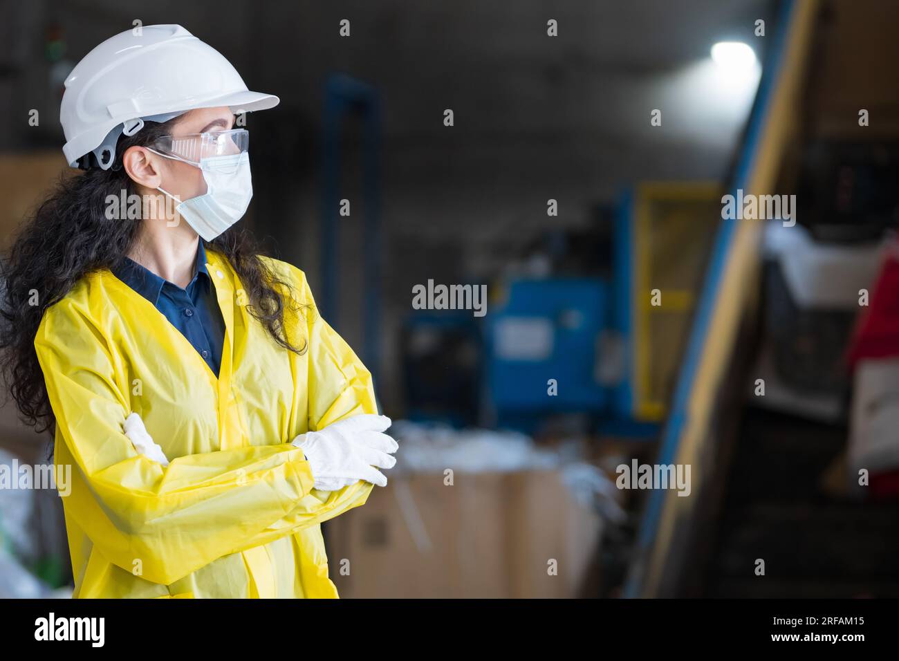 Black-haired female inspector standing against conveyor belt Stock ...