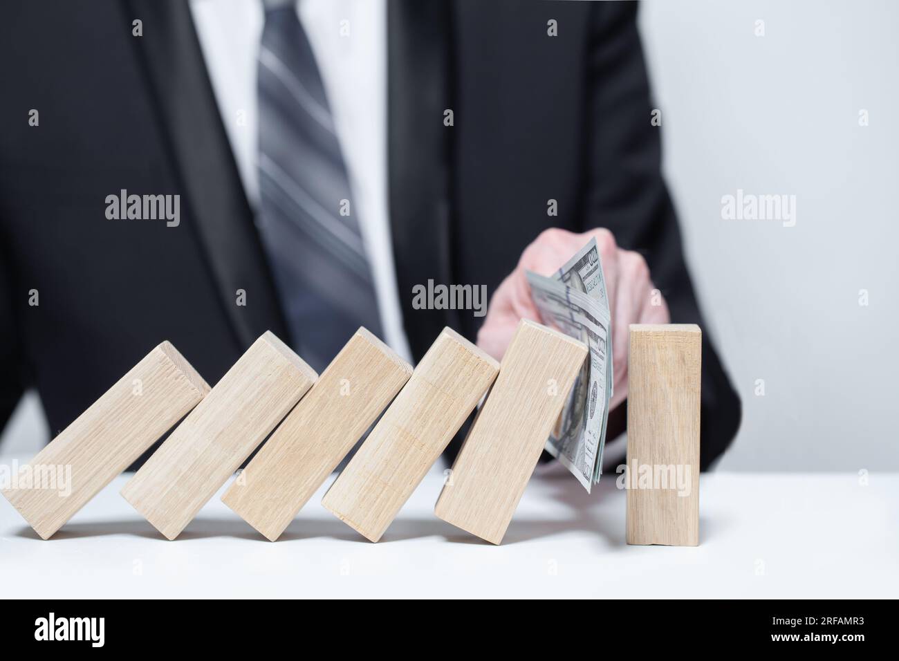 Wooden domino, business strategy, risk, money, balance concept Stock ...
