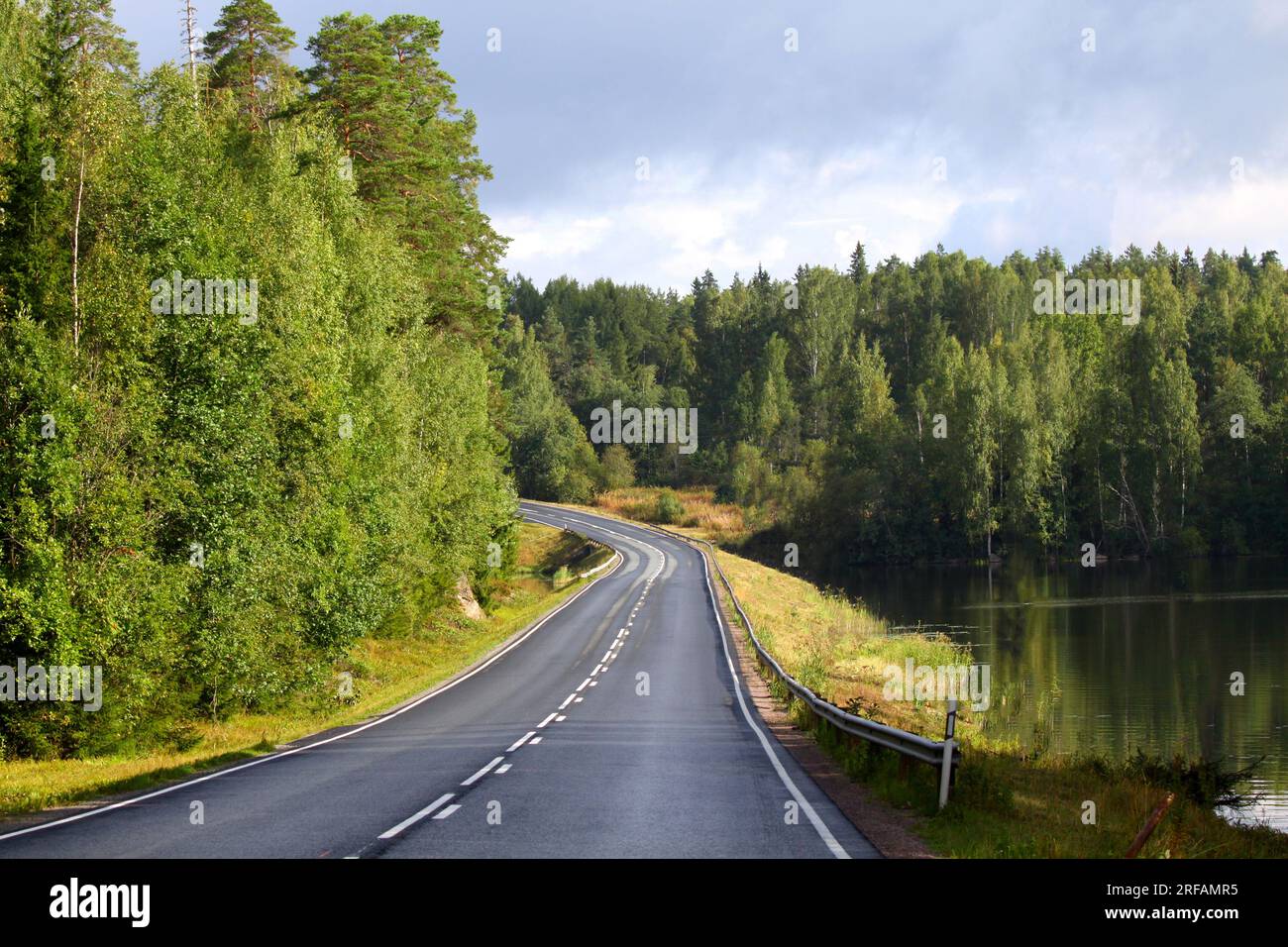 Country road with lake and forest, beautiful landscape Stock Photo - Alamy