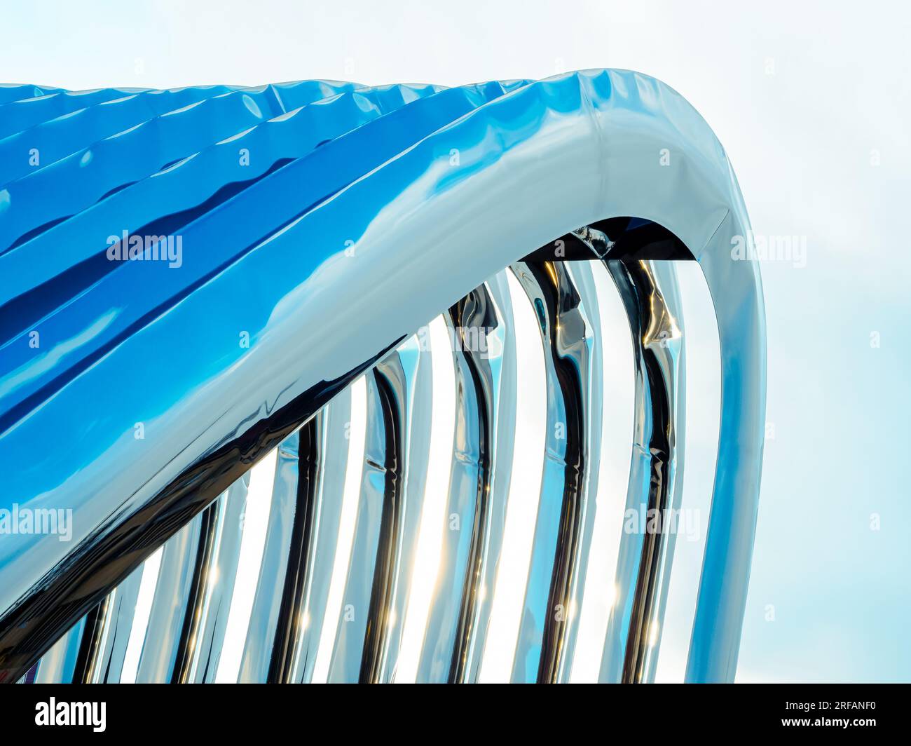 Abstract modern urban metal structure in a row in boomerang curved bent ...