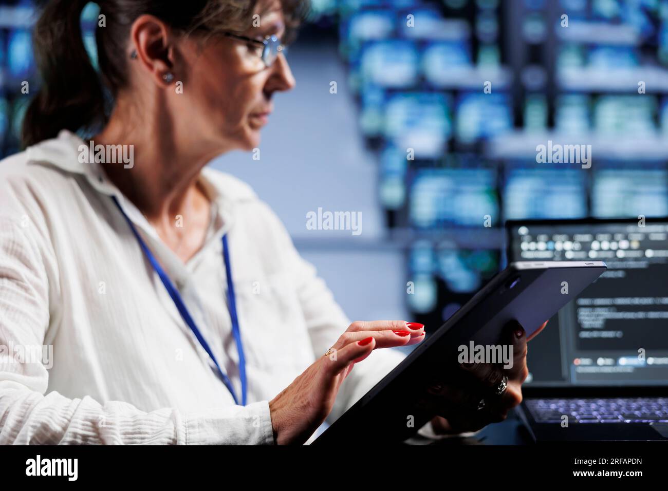 Aged system administrator writing script code in data center on laptop ... Aged system administrator writing script code in data center on laptop ...