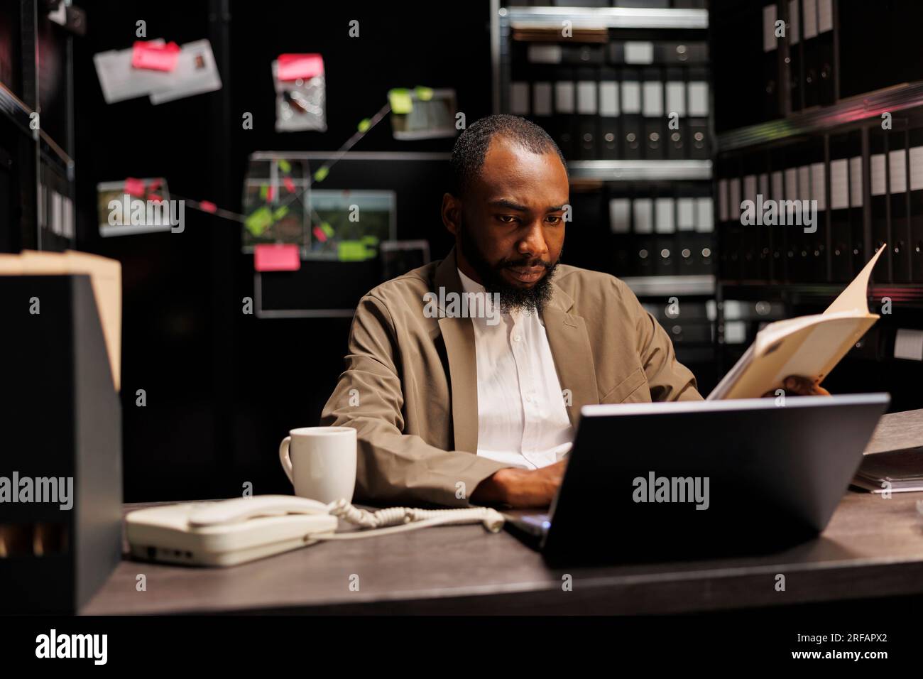 African american detective working late, conducting investigation in ...