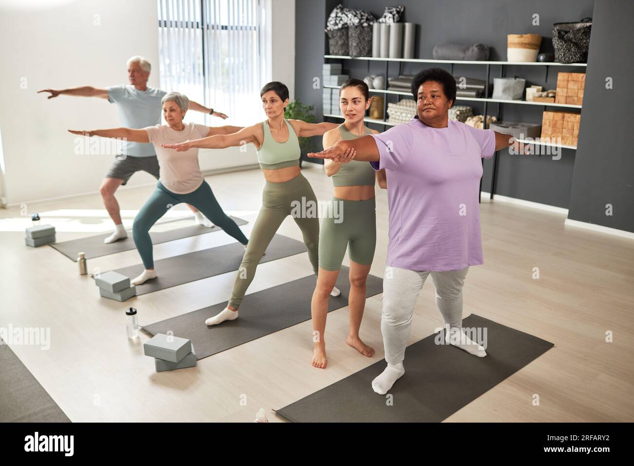 Instructor showing exercises to people during sport training in class ...