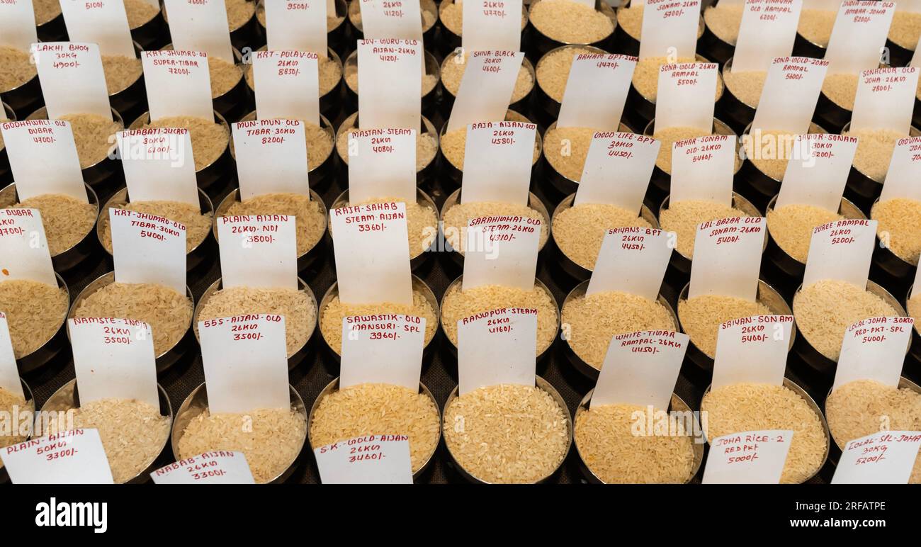 Rice trader displays variety of rice samples at a wholesale store, in ...