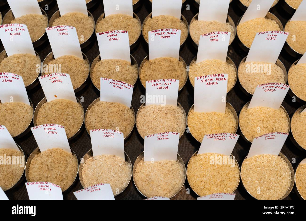 Rice trader displays variety of rice samples at a wholesale store, in ...
