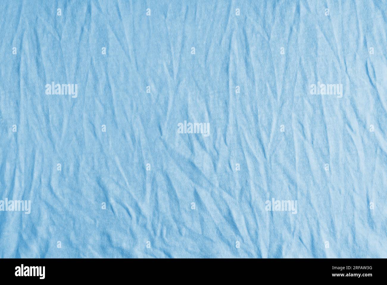 Wrinkled, crumpled blue fabric texture background. Wrinkled and creased ...