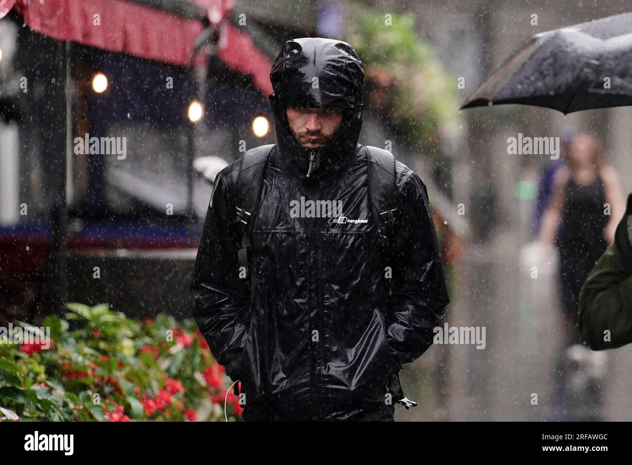 People caught during a heavy downpour of rain in Leicester Square ...