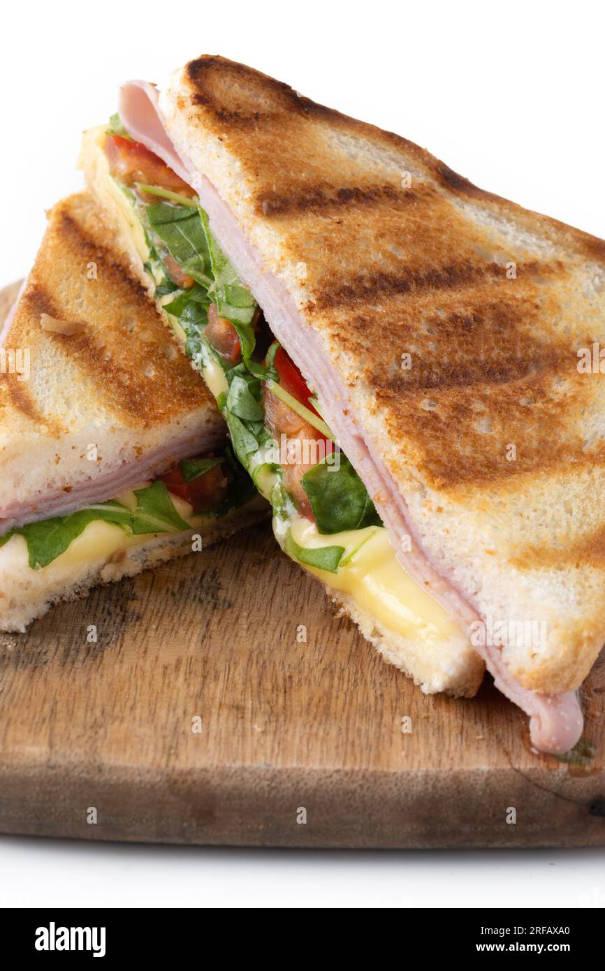 Panini sandwich with ham, cheese, tomato and arugula isolated on white ...