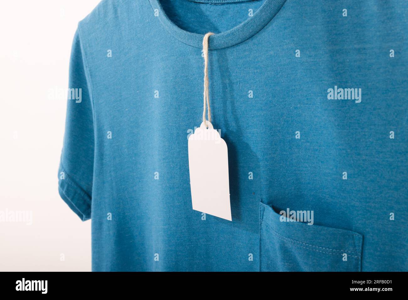 Blue t shirt with tag and copy space on white background Stock Photo ...
