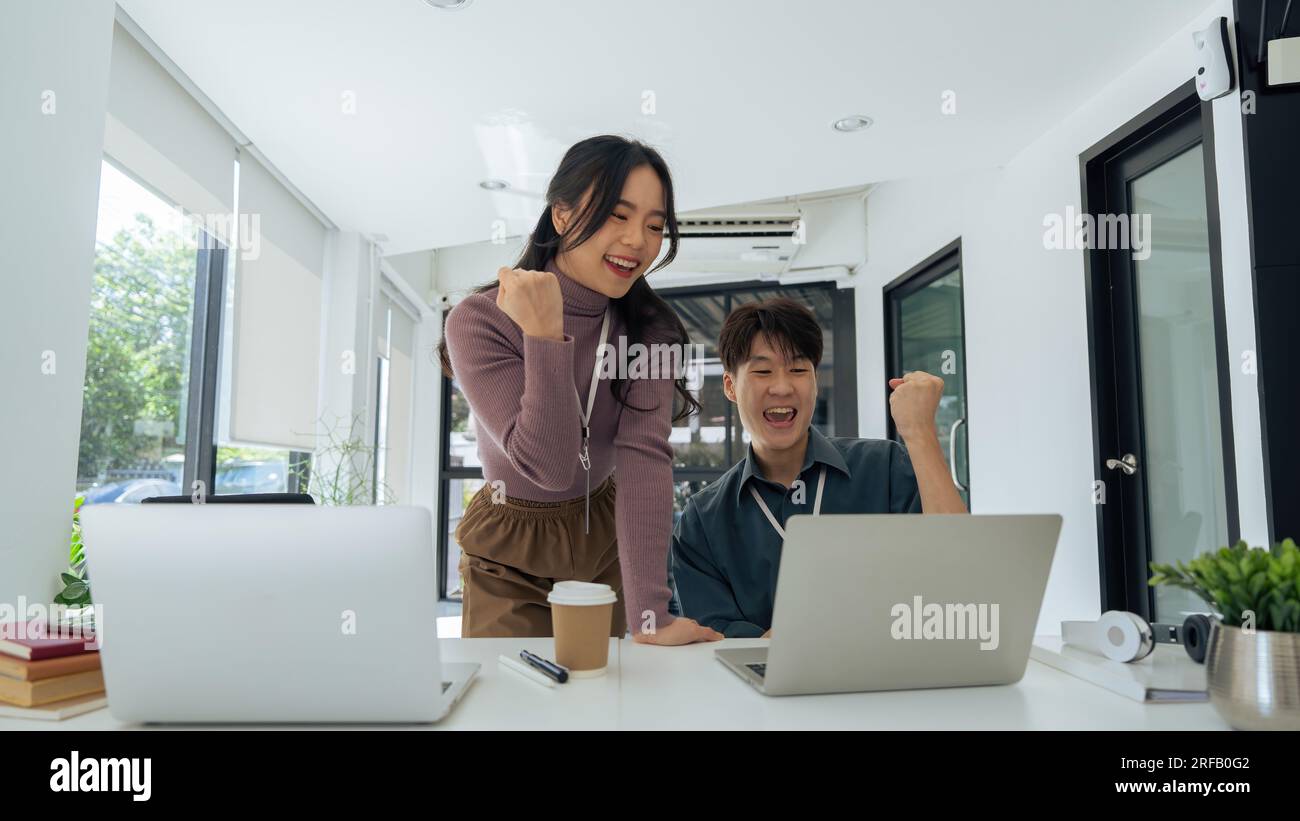 Success of happy employees smiling and laughing to celebrate project ...