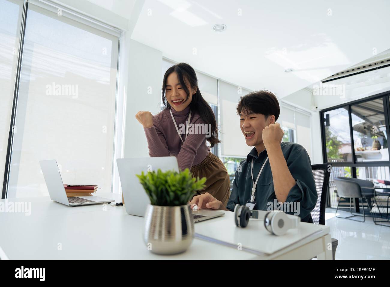 Success of happy employees smiling and laughing to celebrate project ...