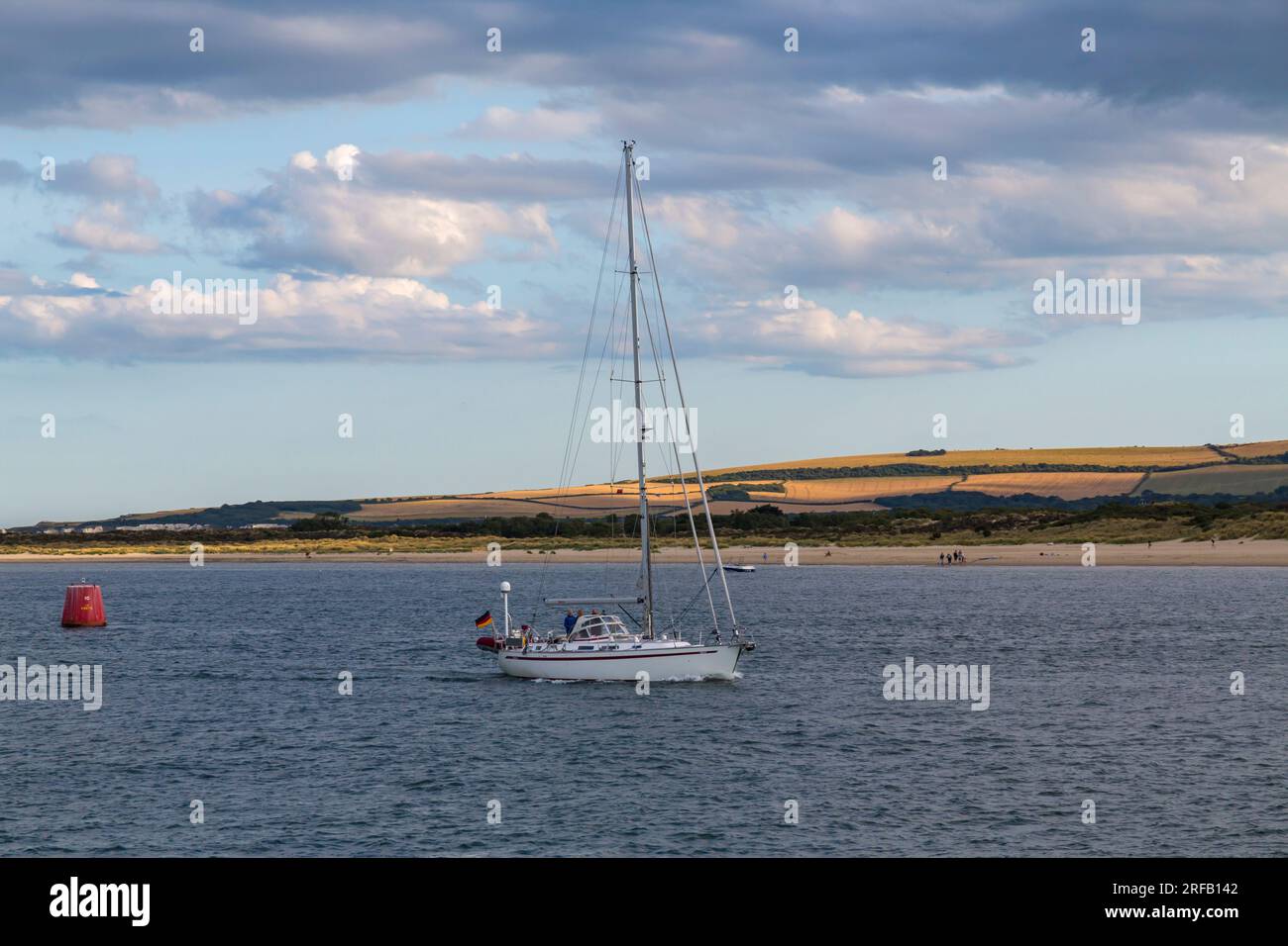 Yacht sailing past the Purbecks and Studland towards Poole Harbour ...