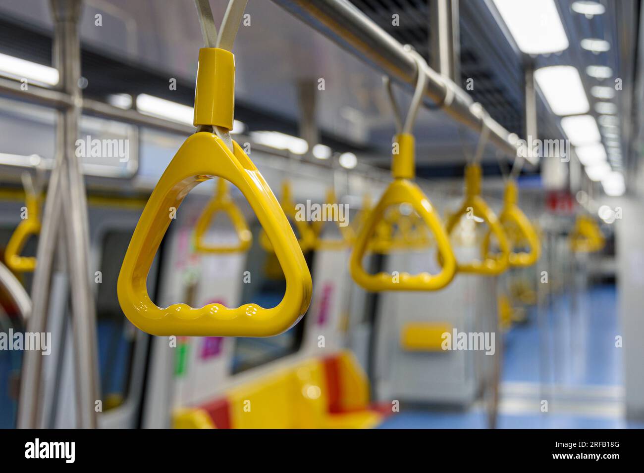Focus on detail of a handle hanging down from a rail on a underground ...